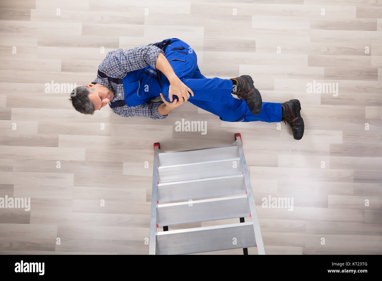 Repairman Fallen From Ladder Stock Photo - Alamy