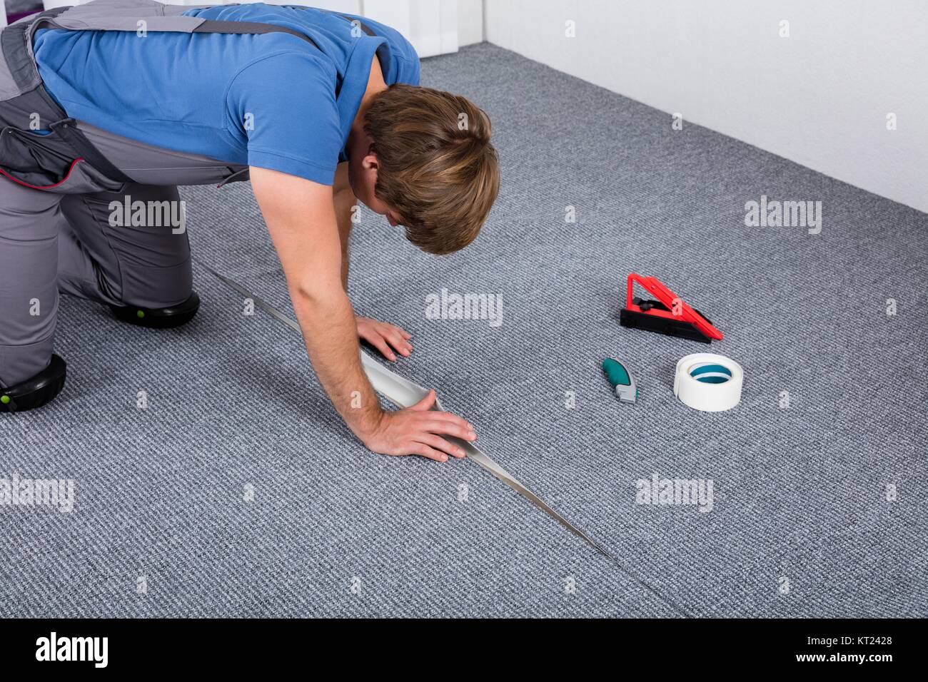 Carpenter Laying Carpet Stock Photo - Alamy