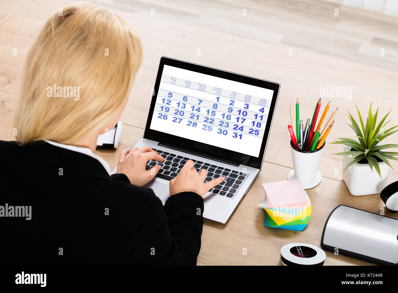 Businesswoman Looking At Calendar On Laptop Stock Photo - Alamy