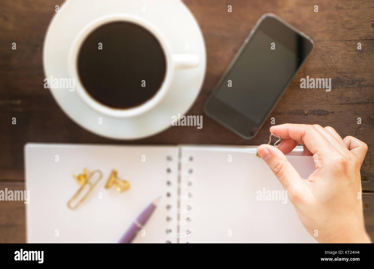Hot cup of coffee on wooden work table Stock Photo - Alamy