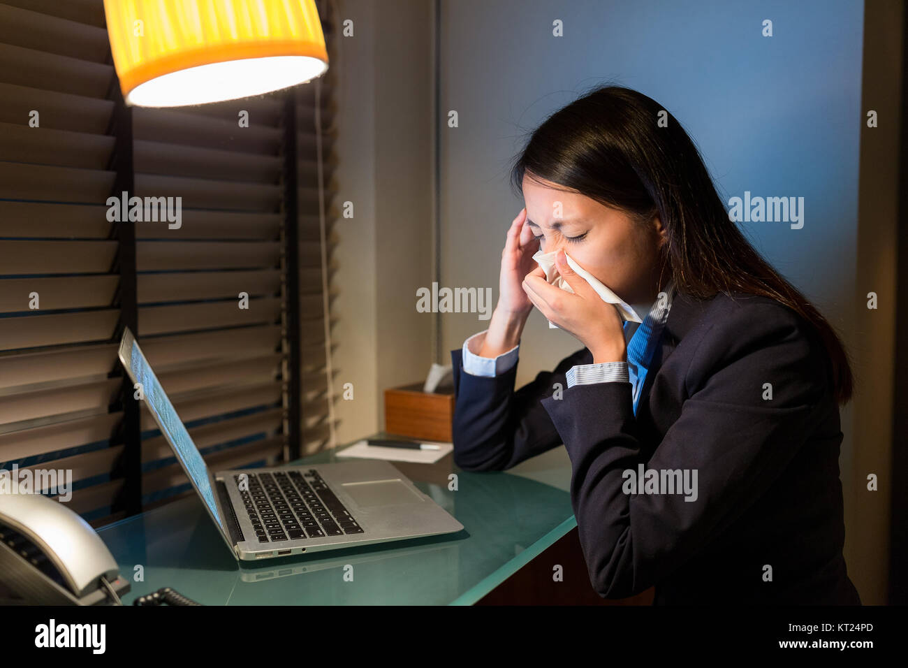 Businesswoman sneeze at office Stock Photo - Alamy