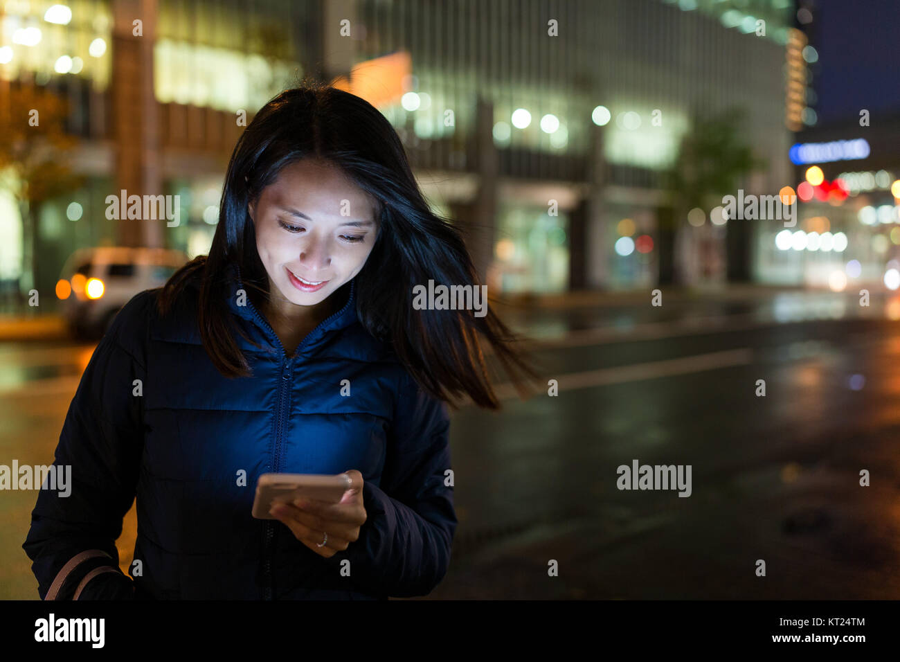 Woman using cellphone at night Stock Photo - Alamy