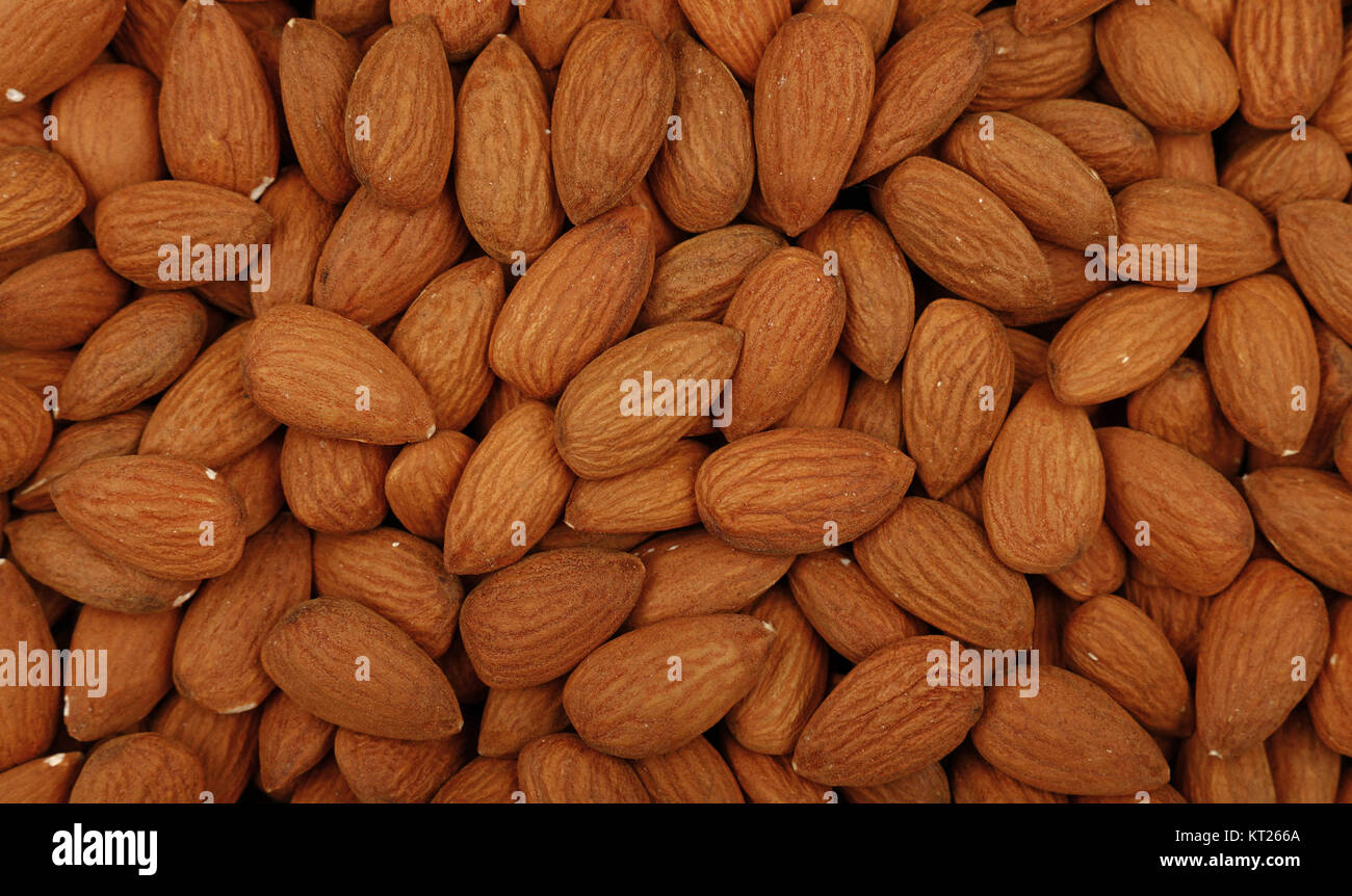 Raw whole almond nuts close up top view Stock Photo - Alamy