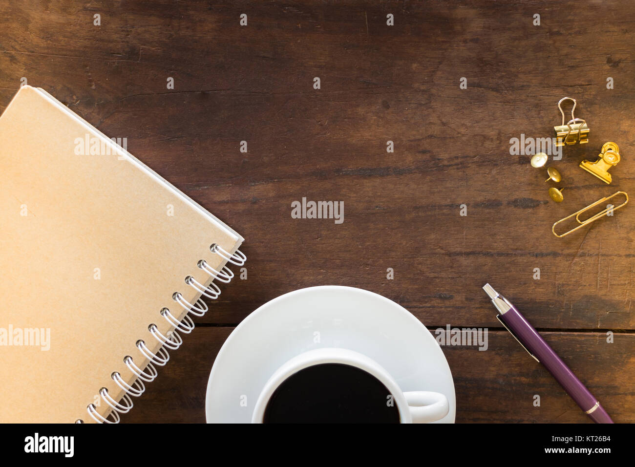 Hot cup of coffee on wooden work table Stock Photo - Alamy