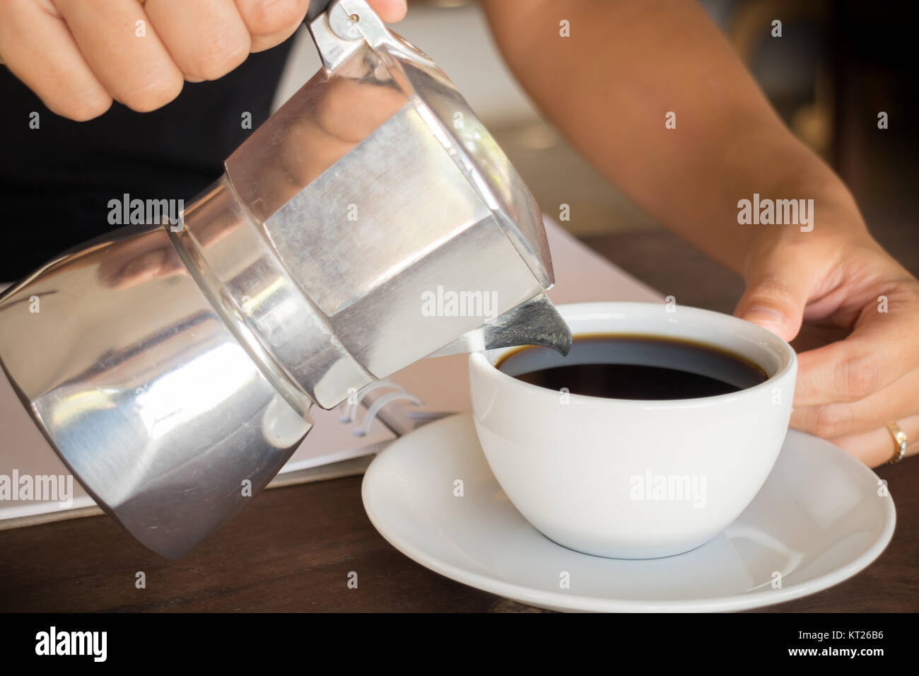 Hand on traditional italian moka pot Stock Photo - Alamy