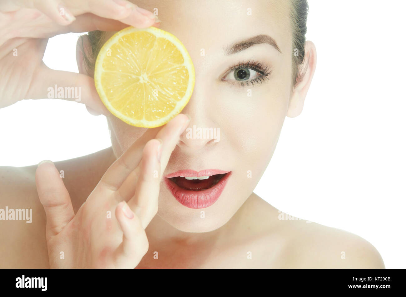beauty, young woman with one halves of a lemon Stock Photo - Alamy