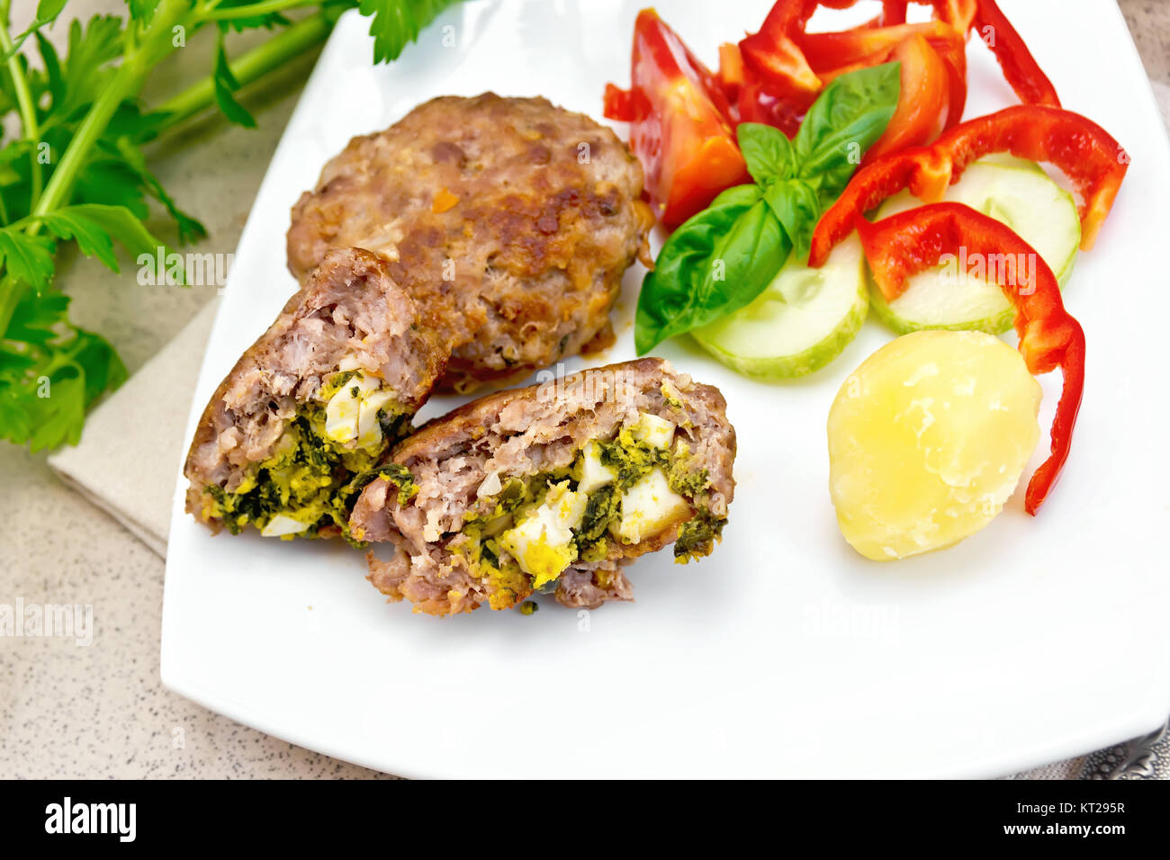Cutlets stuffed in plate on granite table Stock Photo - Alamy