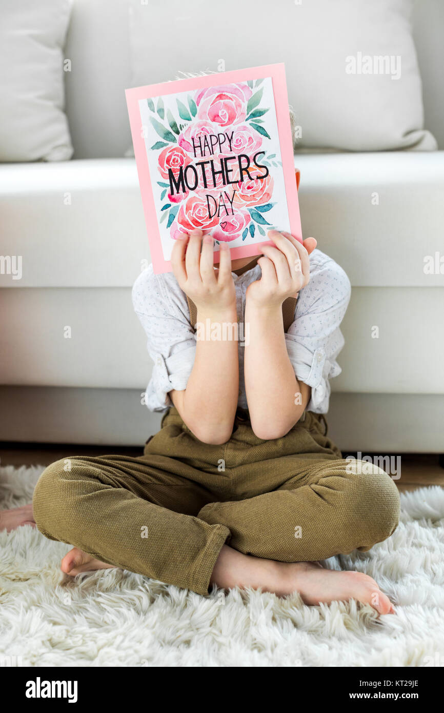Boy with happy mothers day card Stock Photo - Alamy