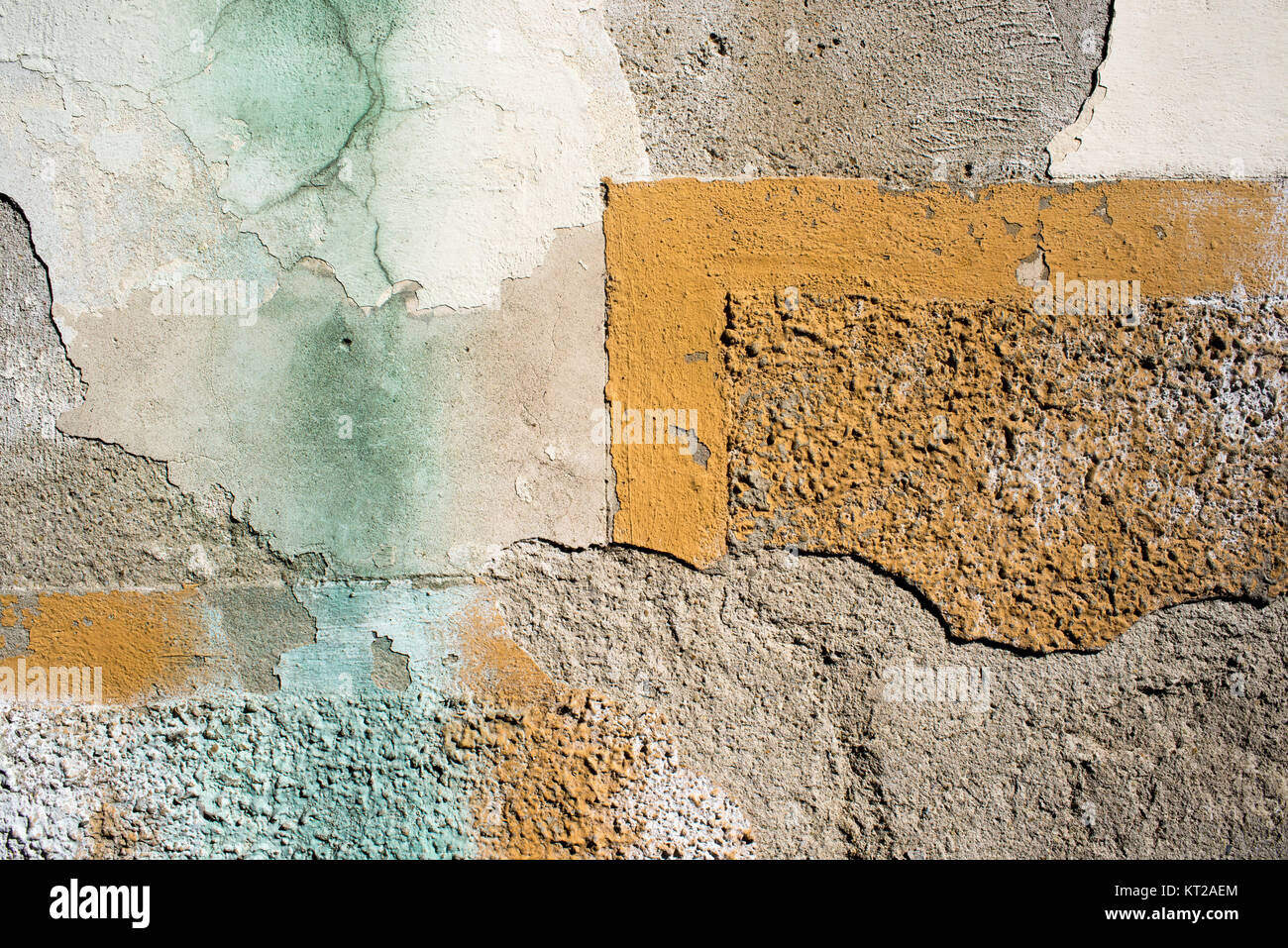 Background of an old wall with peeling plaster and yellow faded paint ...