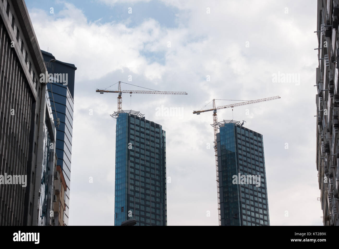Two Cranes Top of Twin Towers Stock Photo - Alamy