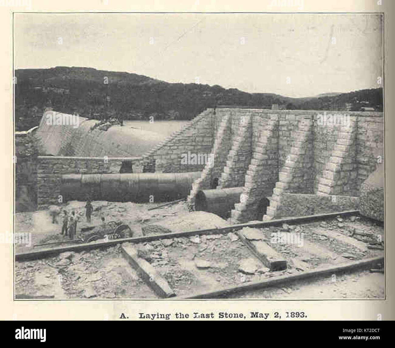 The image shows the laying of the last stone at the 33218 Austin Dam ...