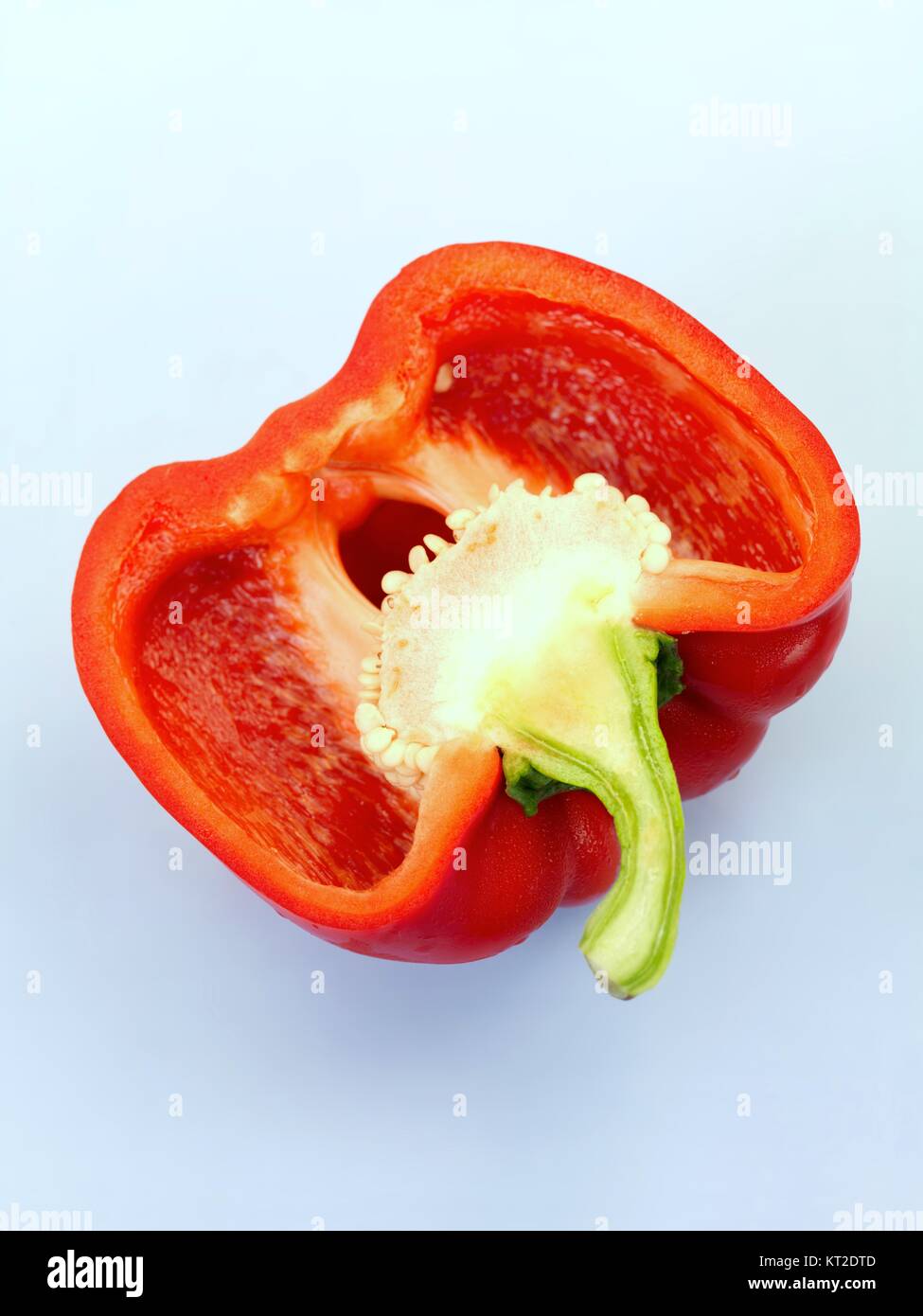 A red capsicum isolated against a blue background Stock Photo - Alamy