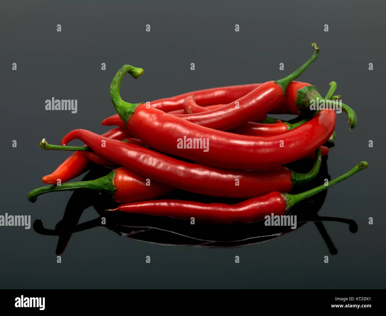 Red chilli peppers isolated against a black background Stock Photo - Alamy
