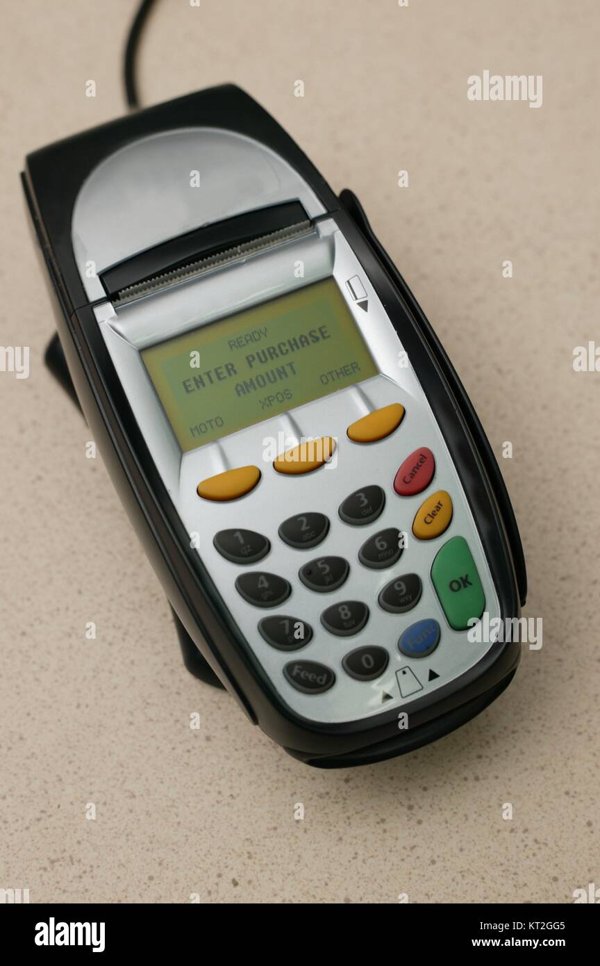 A eftpos machine on a plain background Stock Photo - Alamy