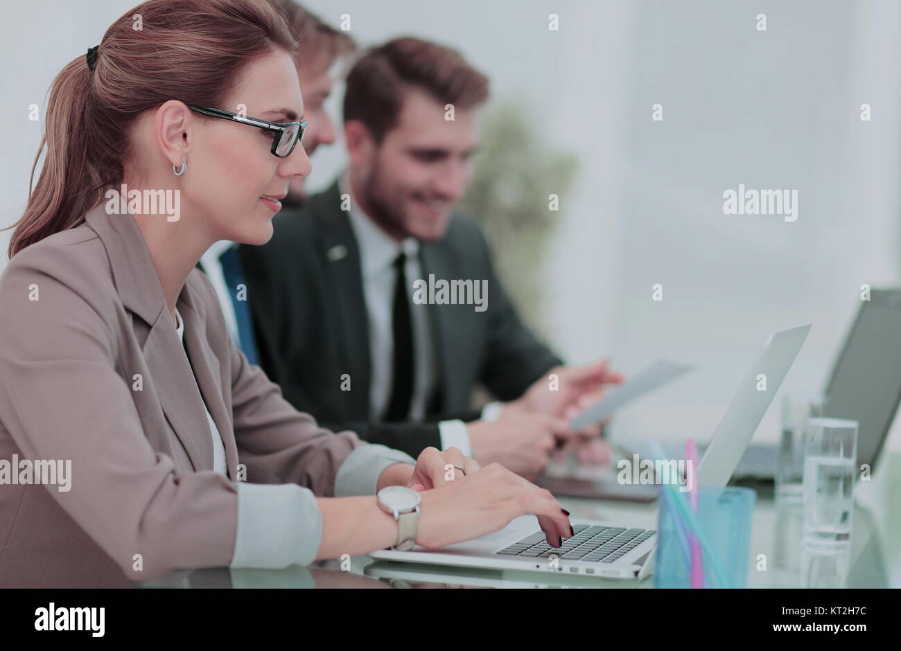 Business people working around table in modern office Stock Photo - Alamy