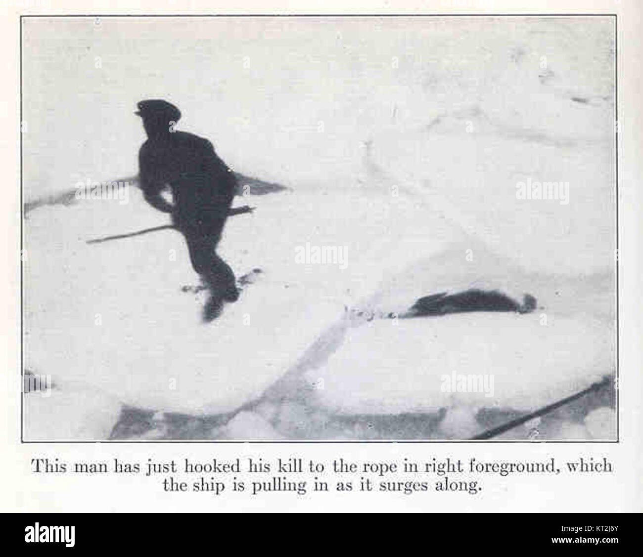 A dramatic photograph depicting a man hooking a catch to a rope aboard ...