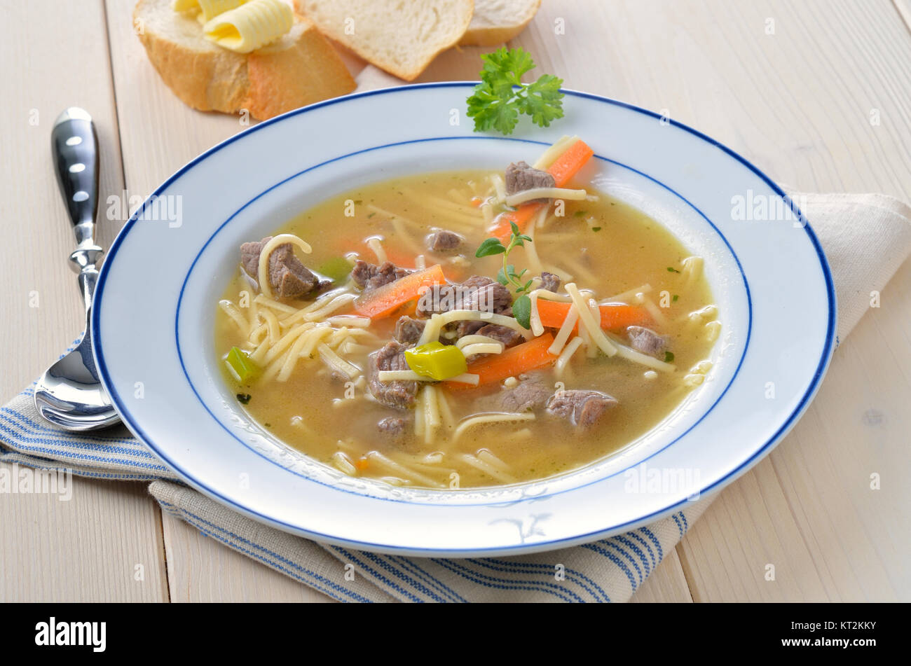 Beef bouillon with noodles and pieces of meat Stock Photo - Alamy