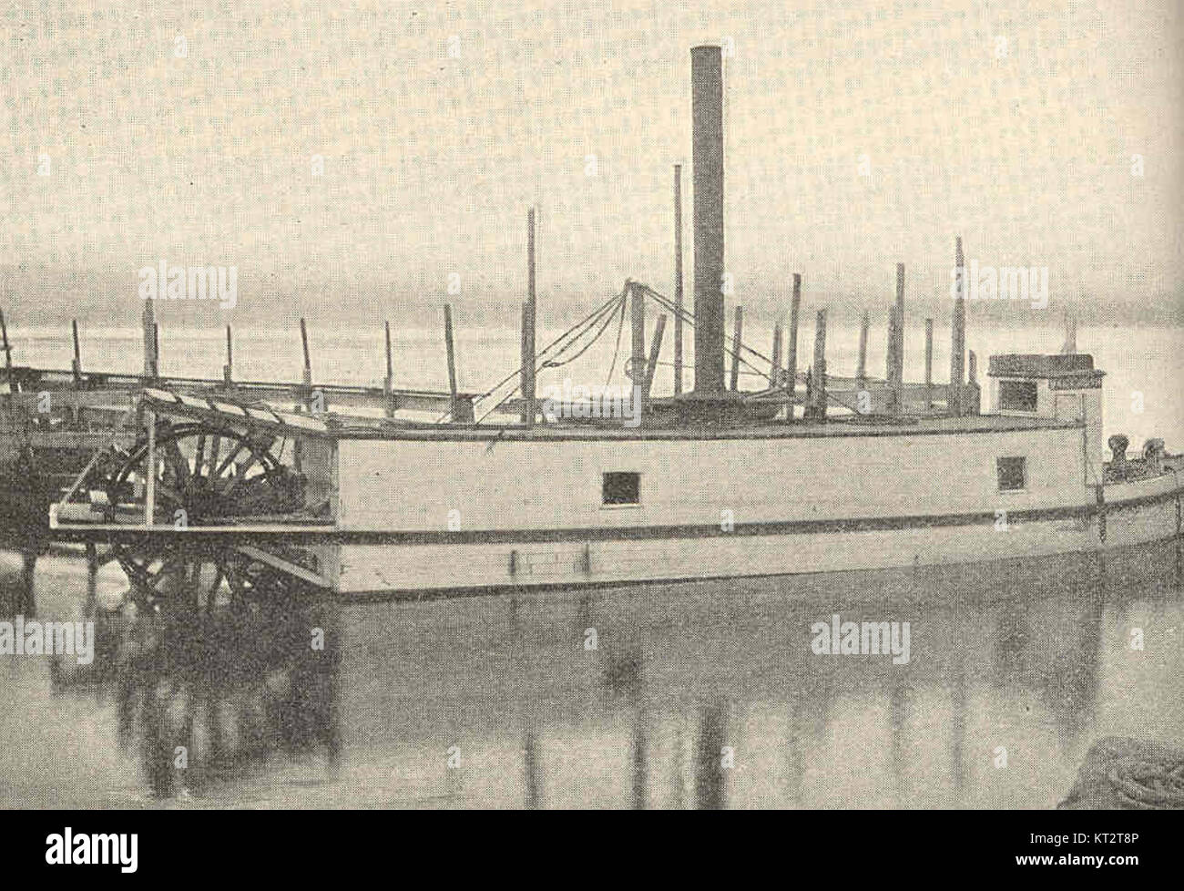 This image depicts a stern-wheel steamer, commonly used in the early ...
