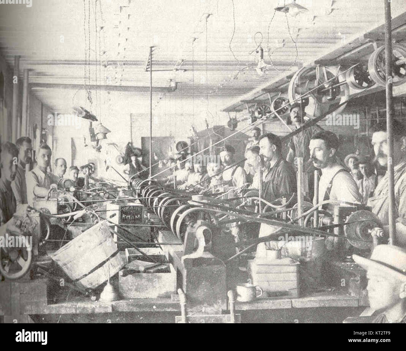 The image depicts the interior of a button factory where rough blanks ...