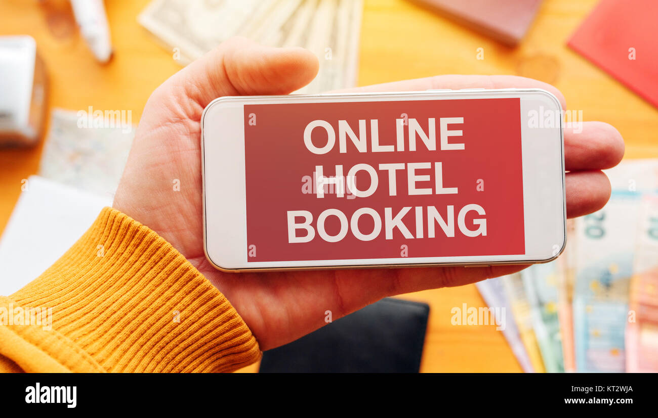 Online hotel booking app. Man holding smartphone with mock up ...