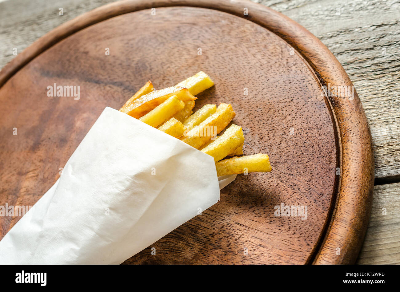 French fries in a paper wrapper Stock Photo - Alamy