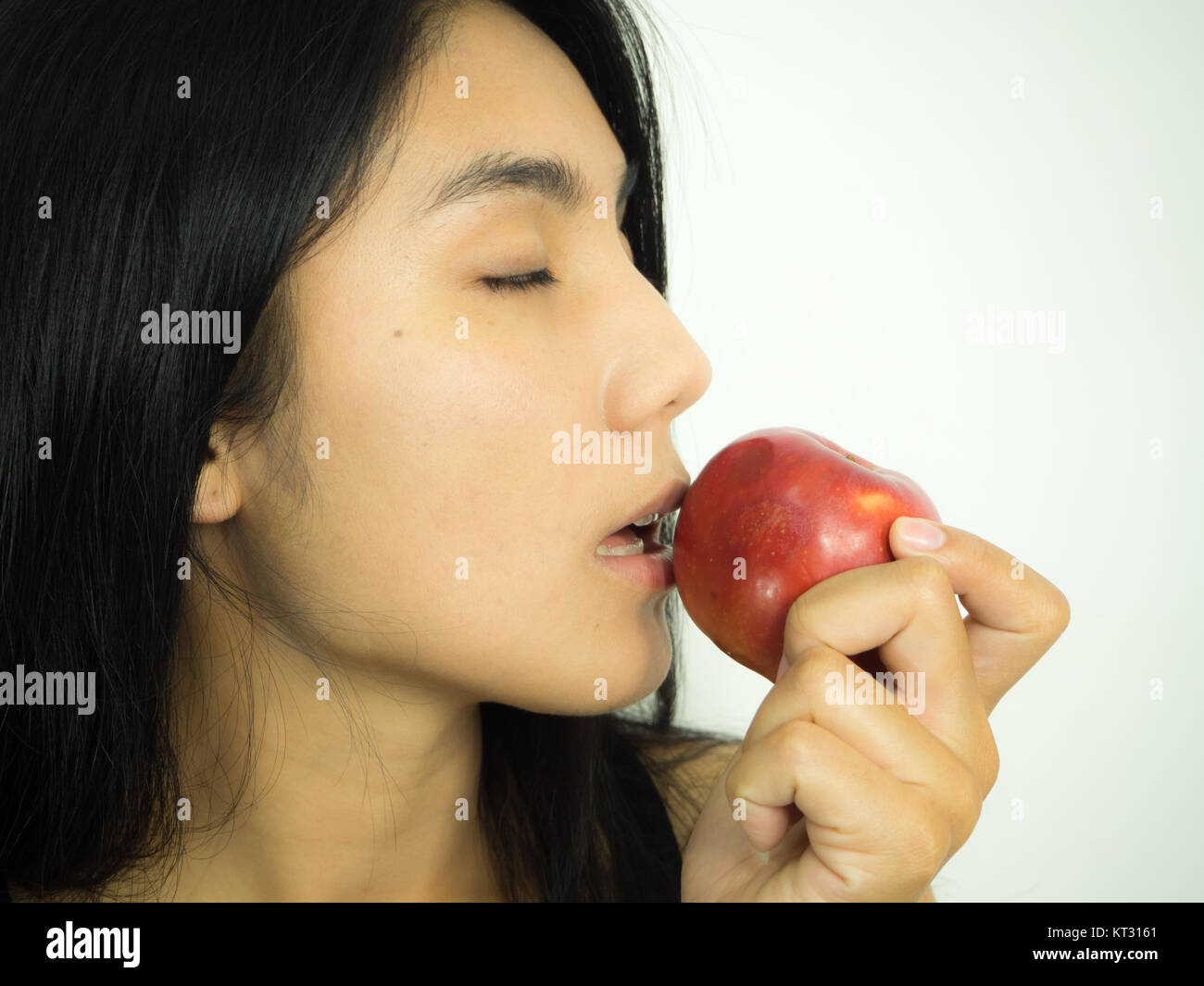 Close-up Asian woman eating red apple on white background Stock Photo ...