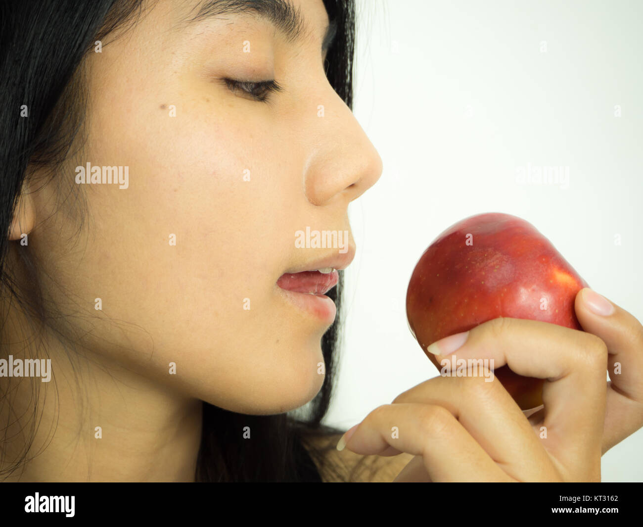 Close-up Asian woman eating red apple on white background Stock Photo ...