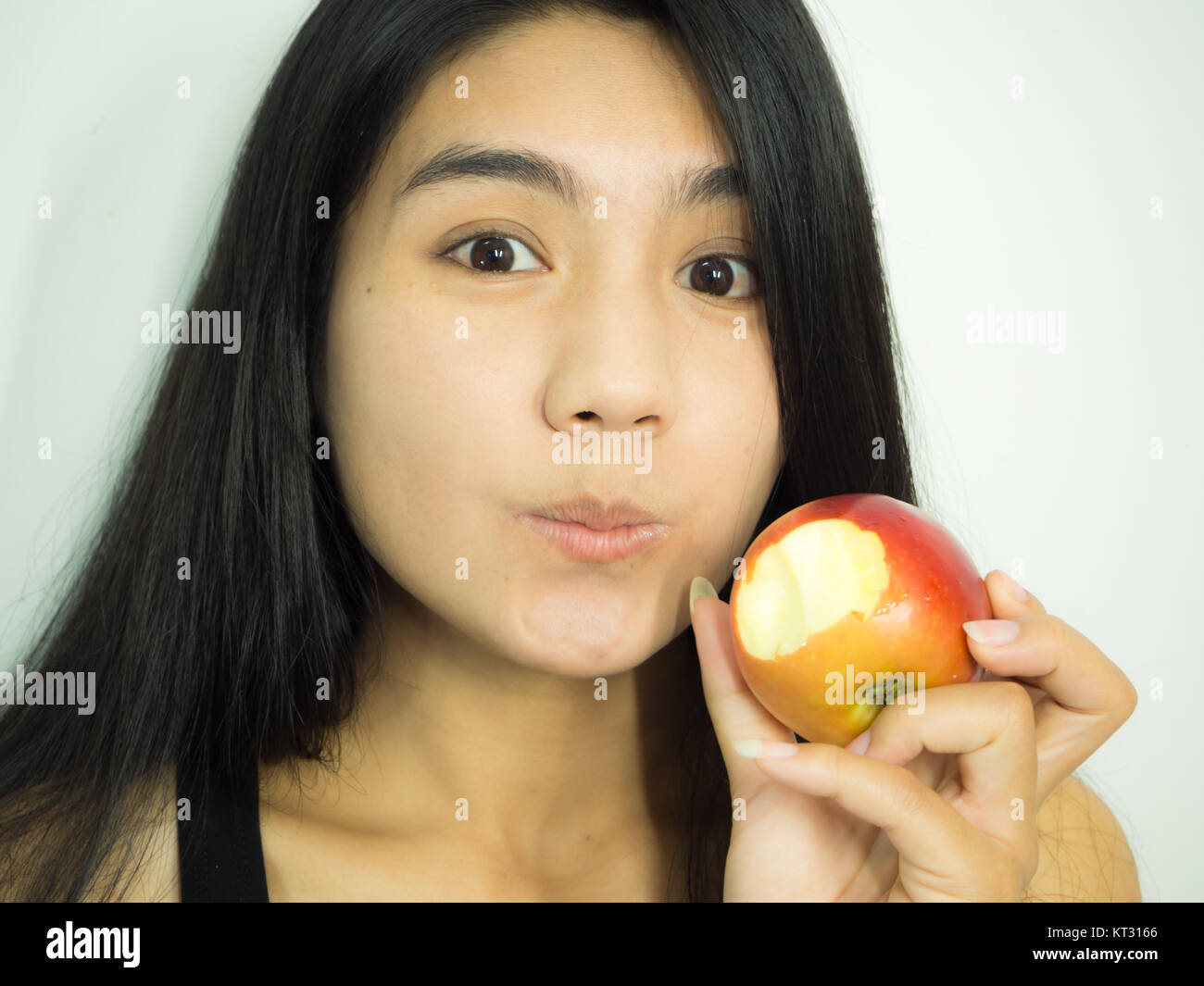 Asian woman eating red apple on white background Stock Photo - Alamy