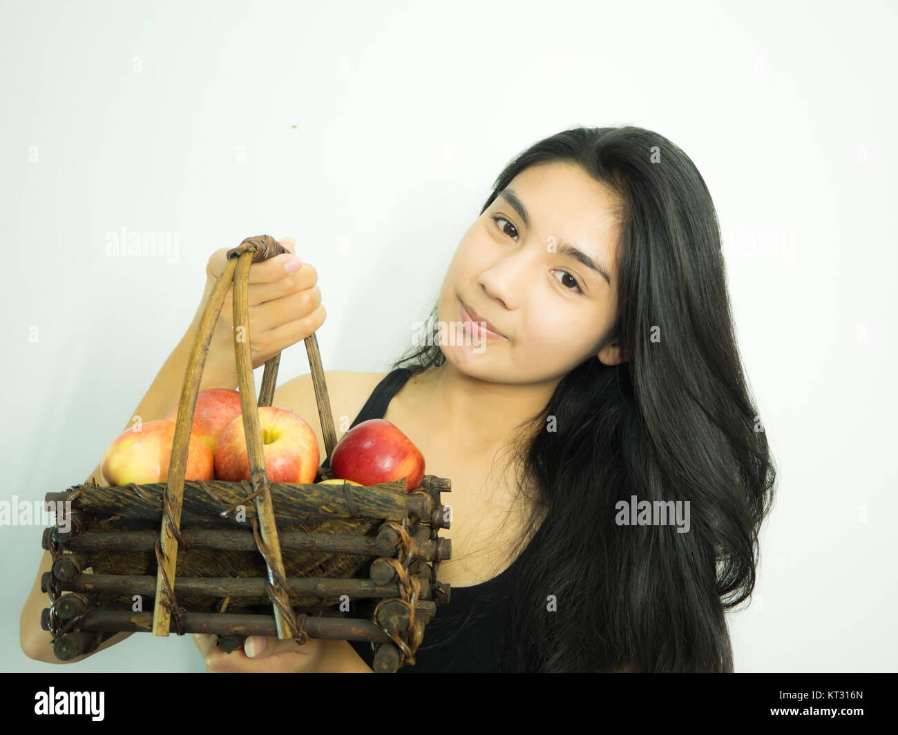 Asian woman smilling red apple on white background Stock Photo - Alamy