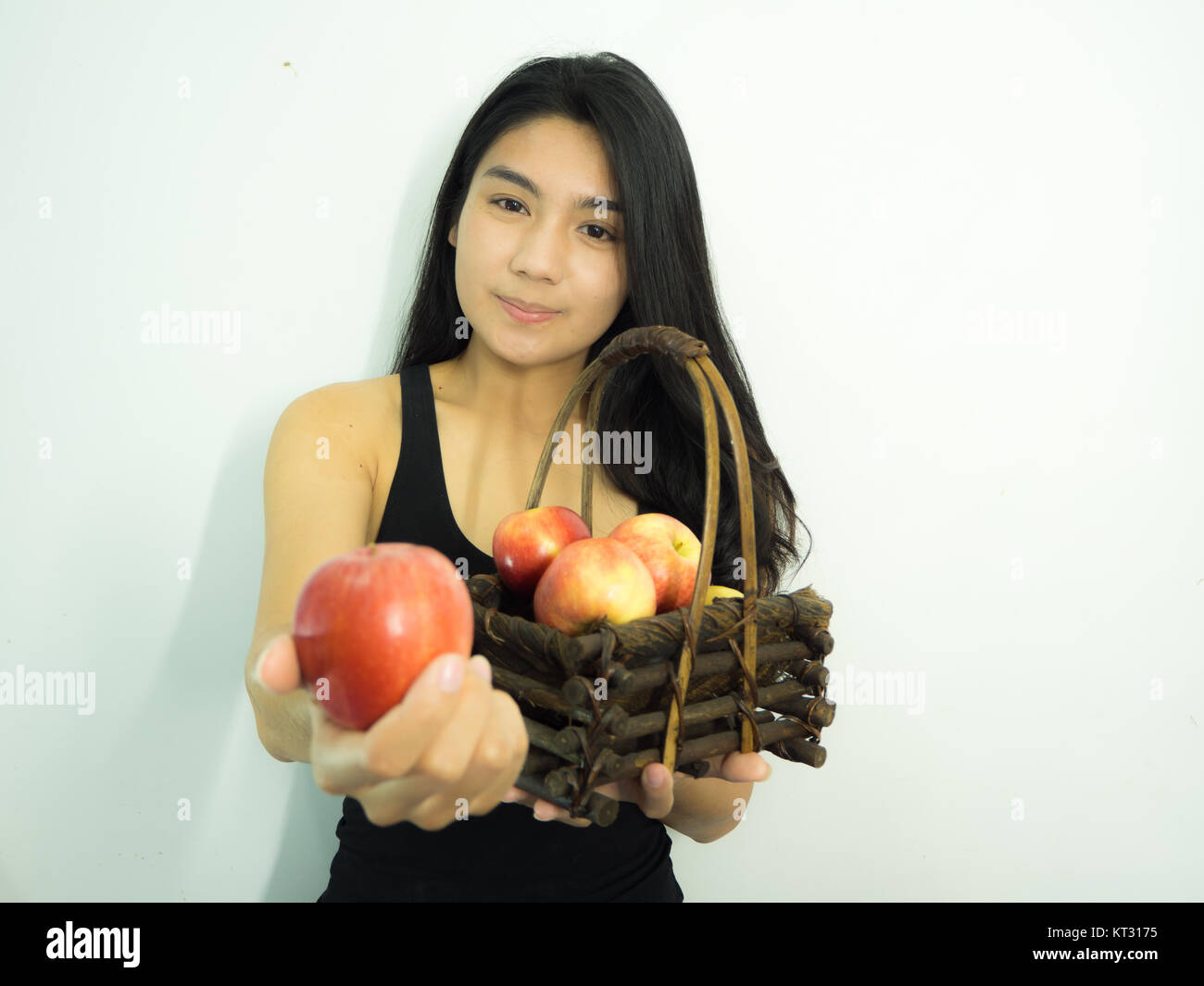 Asian woman smilling red apple on white background Stock Photo - Alamy