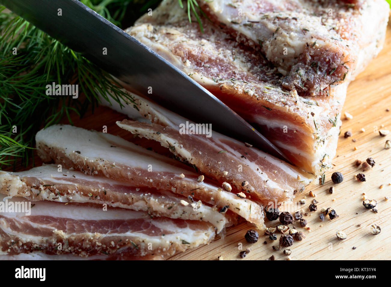 Slices of salty bacon with spices on a wooden table Stock Photo - Alamy