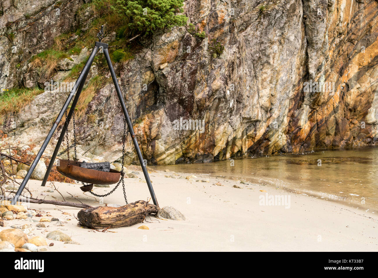 Large rusty fire pit or BBQ on beach in Norwegian fjord Stock Photo - Alamy