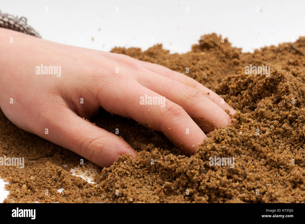 hand with buried in the sand fingers Stock Photo - Alamy