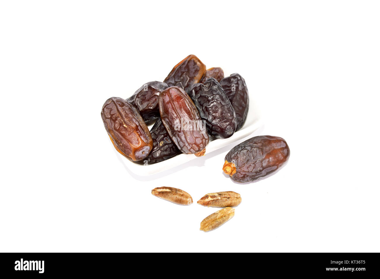 White background in plate with fruit and date- fruit seed pictures ...