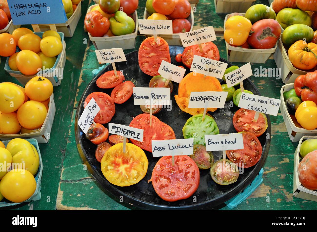 Sliced arrangement of colorful heirloom tomato types on display at ...