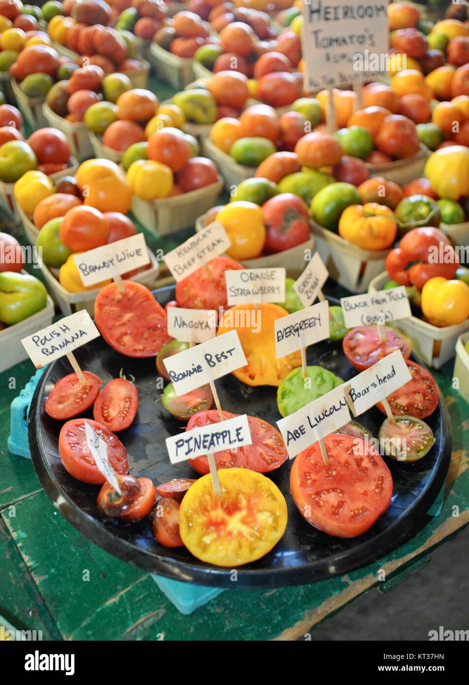Sliced arrangement of colorful heirloom tomato types on display at ...
