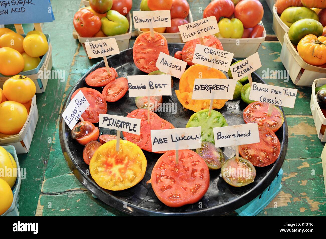 Sliced arrangement of colorful heirloom tomato types on display at ...