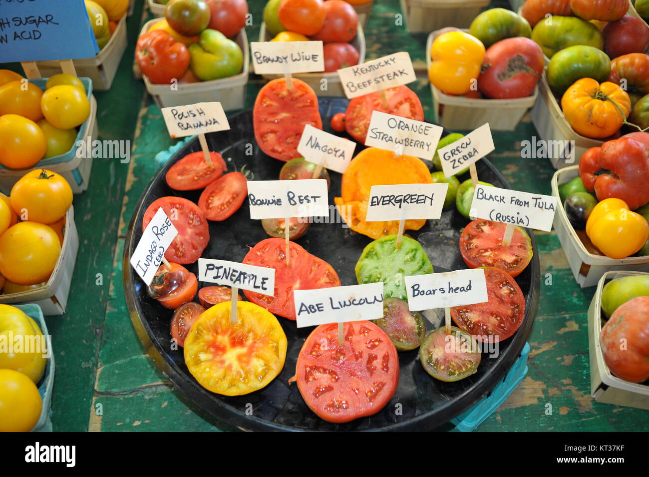 Sliced arrangement of colorful heirloom tomato types on display at ...