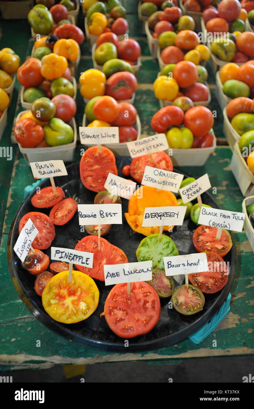 Sliced arrangement of colorful heirloom tomato types on display at ...