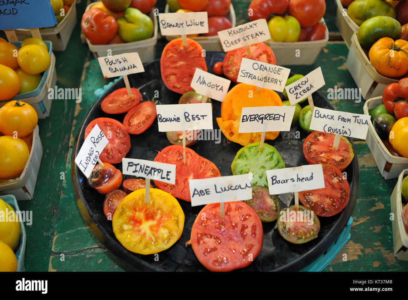 Sliced arrangement of colorful heirloom tomato types on display at ...