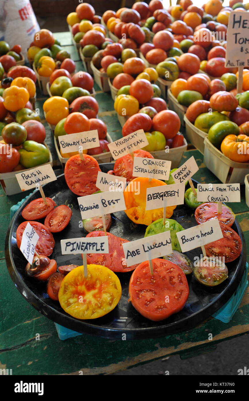 Sliced arrangement of colorful heirloom tomato types on display at ...