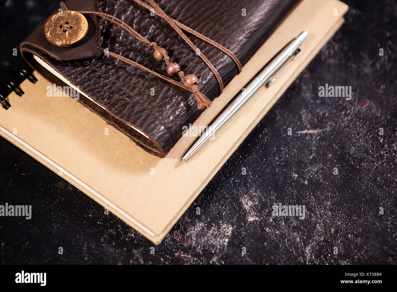 Top view on aged retro notebook with leather cover on dark wooden ...
