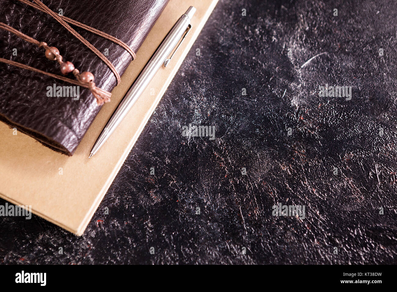 Hand made retro aged notebook diary on a dark board in close up photo ...