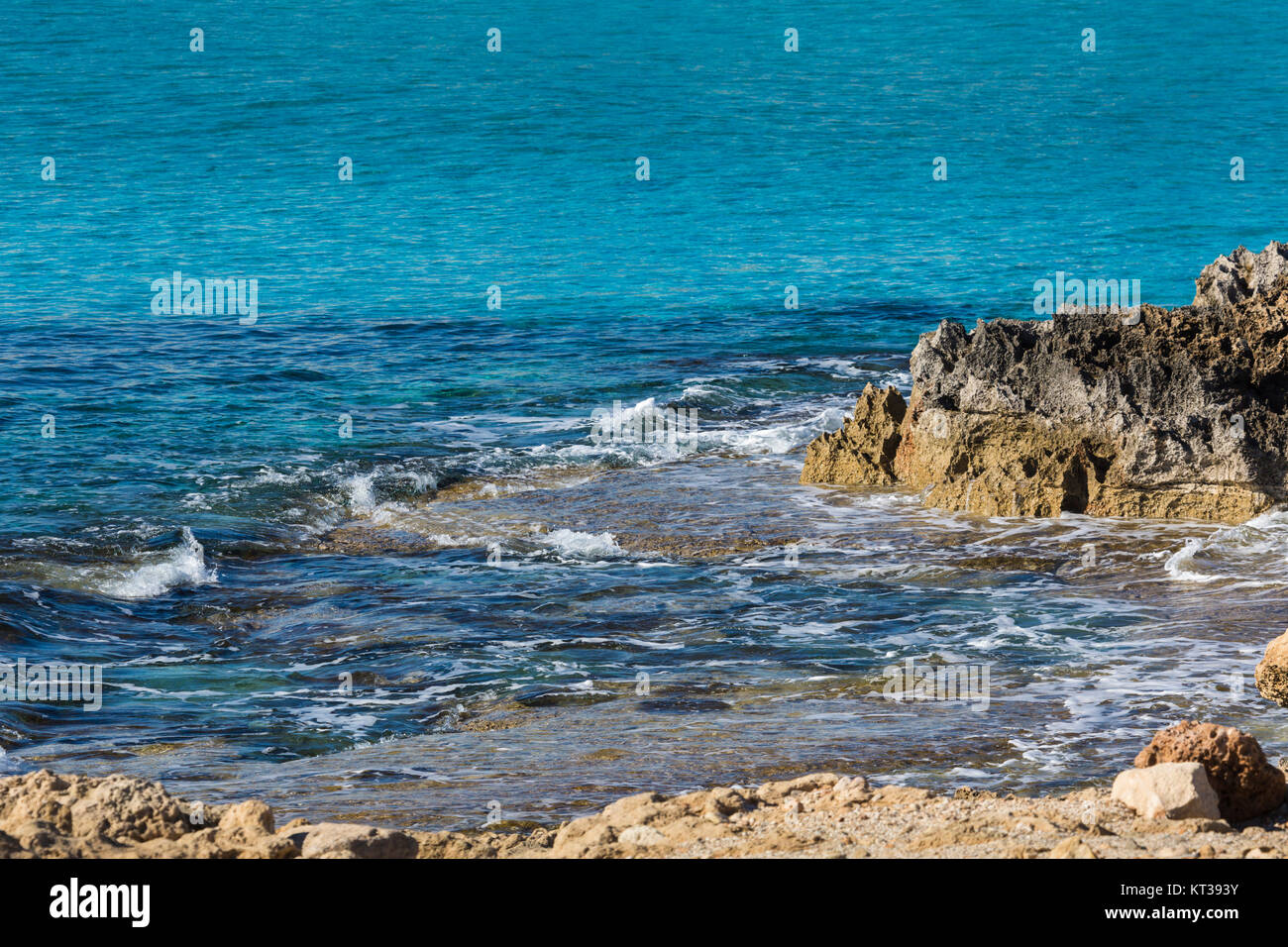 wild beach with rocks in water Stock Photo - Alamy