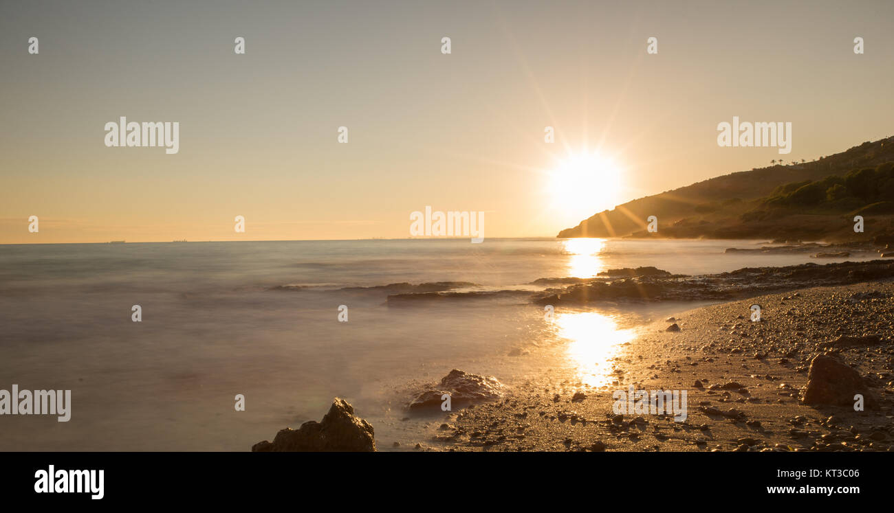 The calm sea in a very cloudy sunset in Spain Stock Photo - Alamy