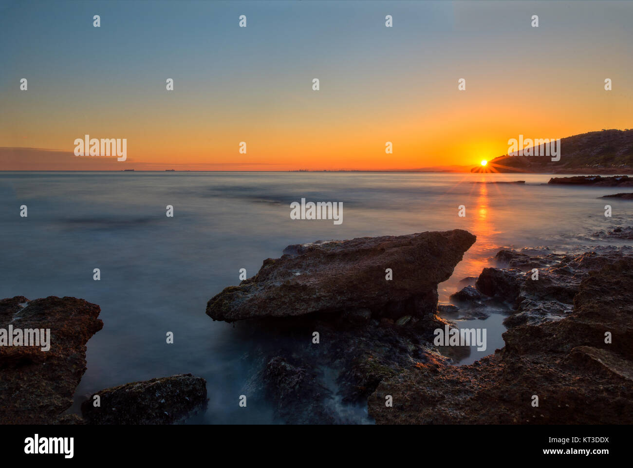 The calm sea in a very cloudy sunset in Spain Stock Photo - Alamy