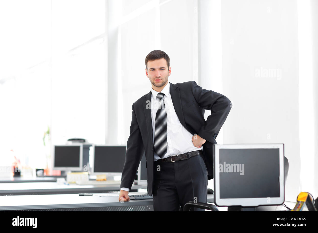 senior Manager standing in a modern office before the start of the ...