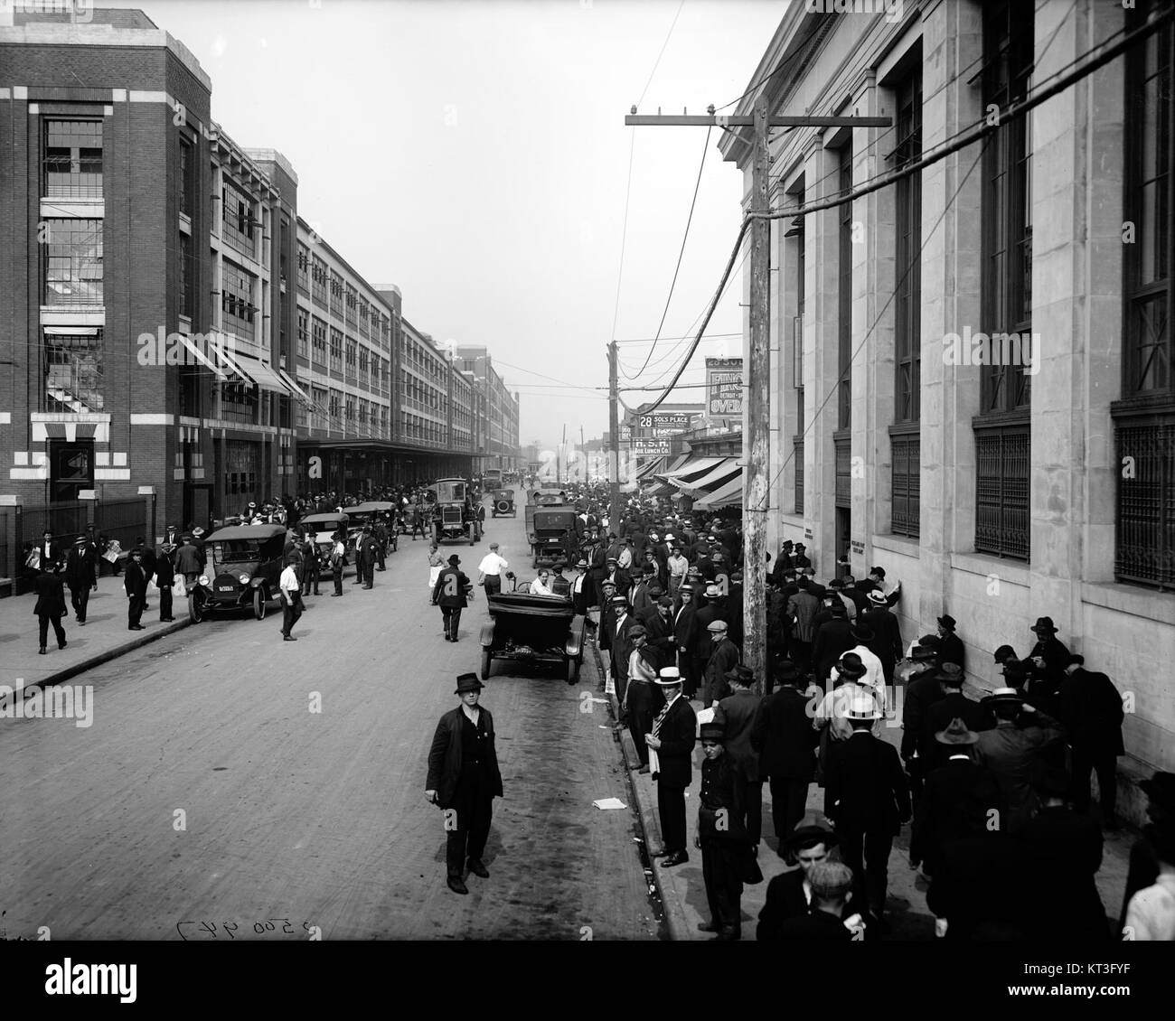 The image depicts a shift change at the Ford Motor Company during the ...