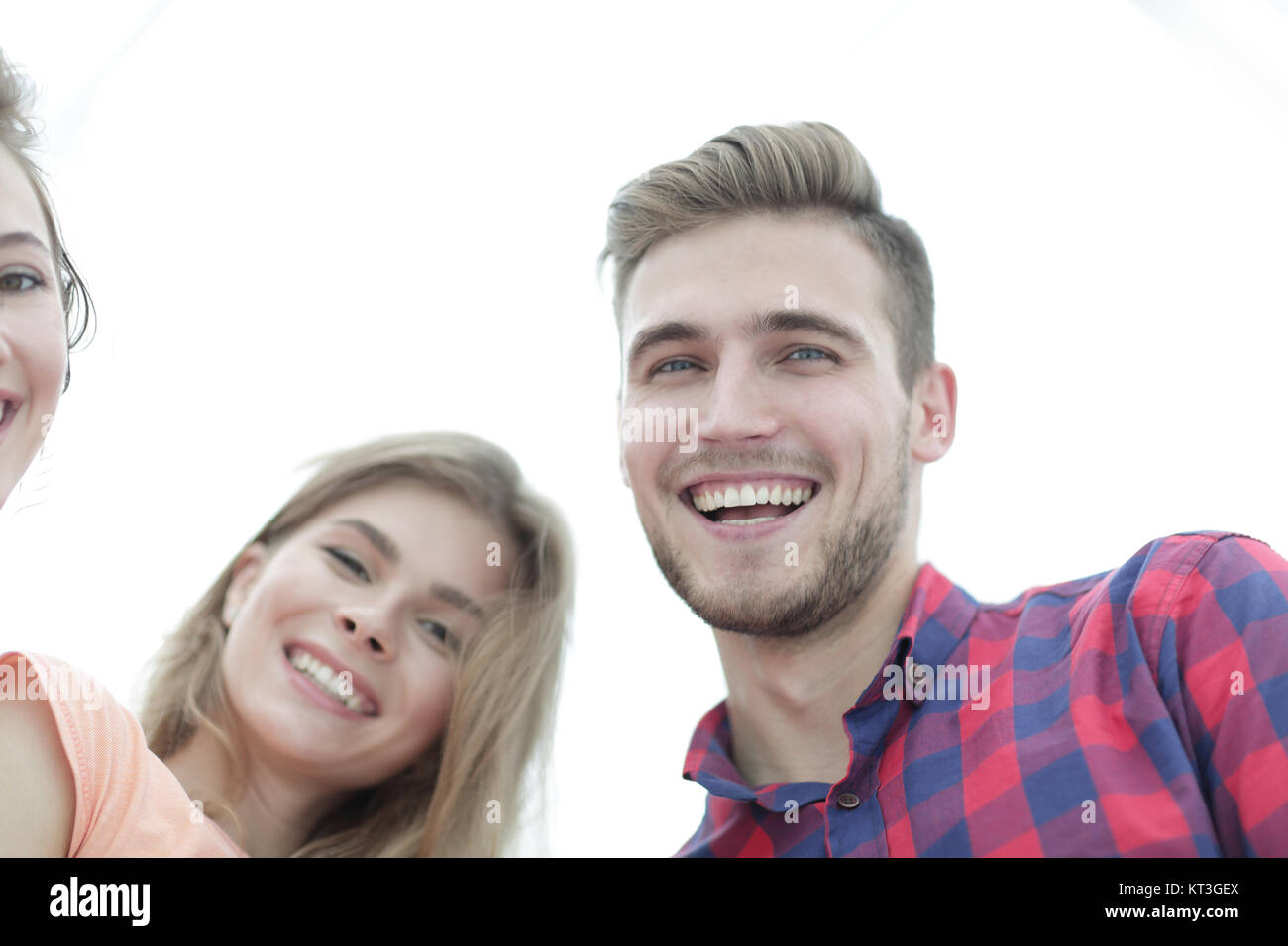 closeup of three young people smiling on white background Stock Photo ...