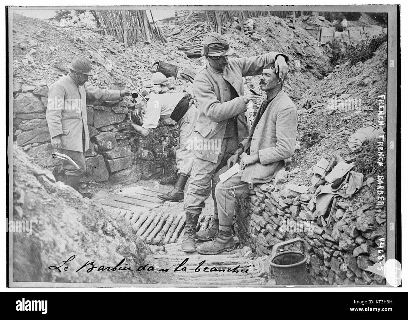 Photograph capturing a French soldier receiving a haircut in a trench ...